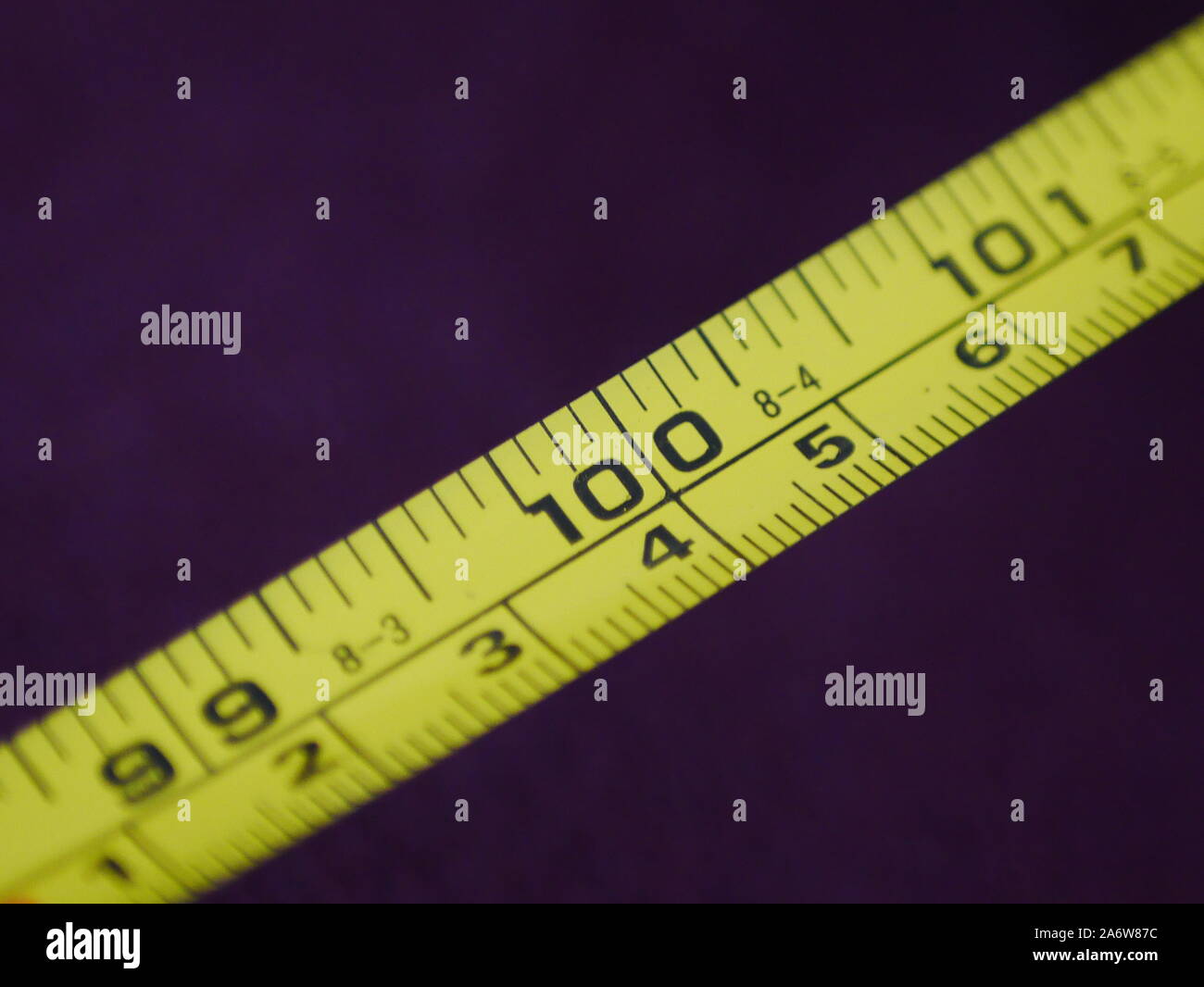 Close up of one hundred centimetre marking on a yellow tape measure ...