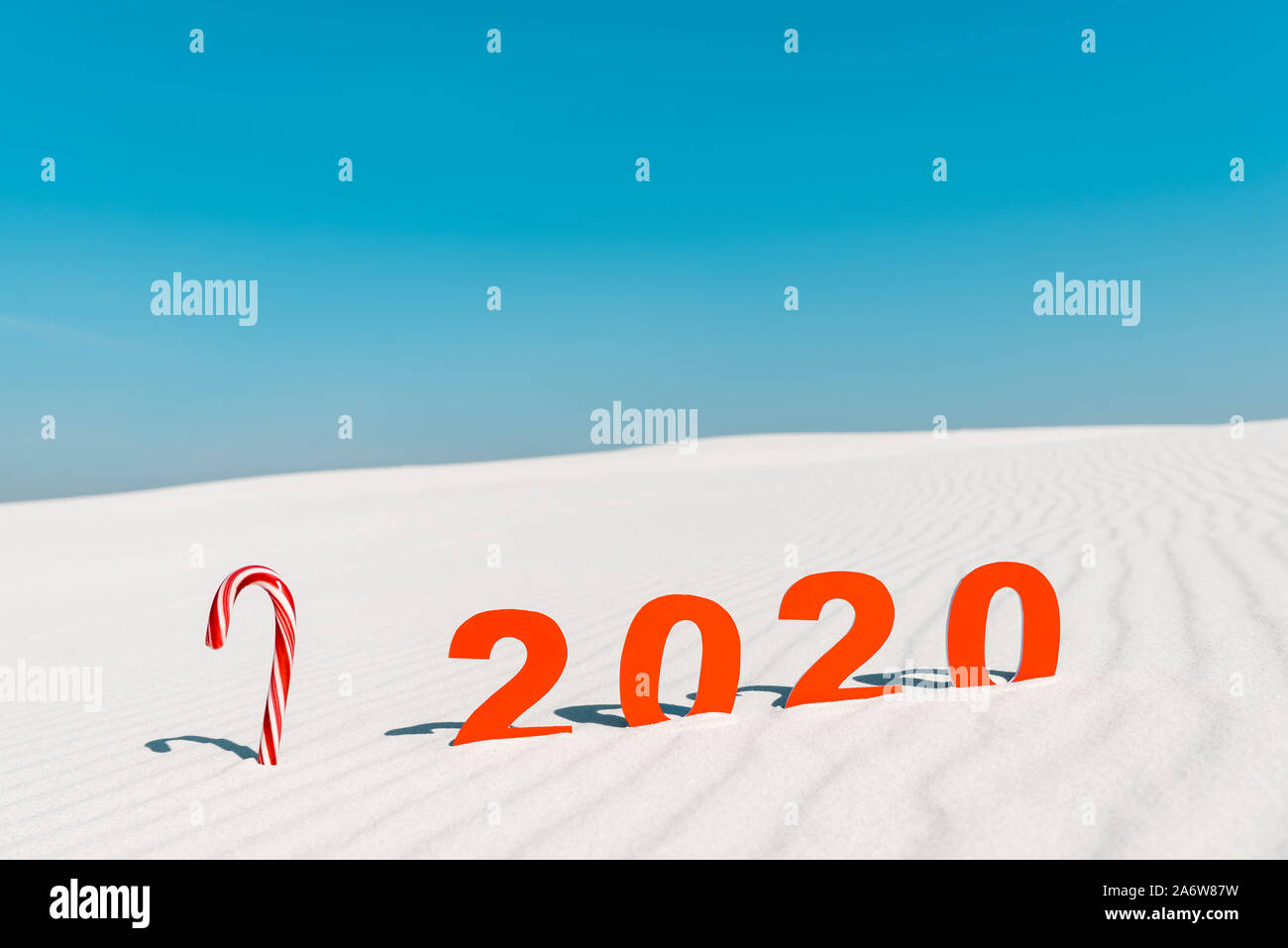 2020 numbers and candy cane on white sand on beach in Maldives Stock ...