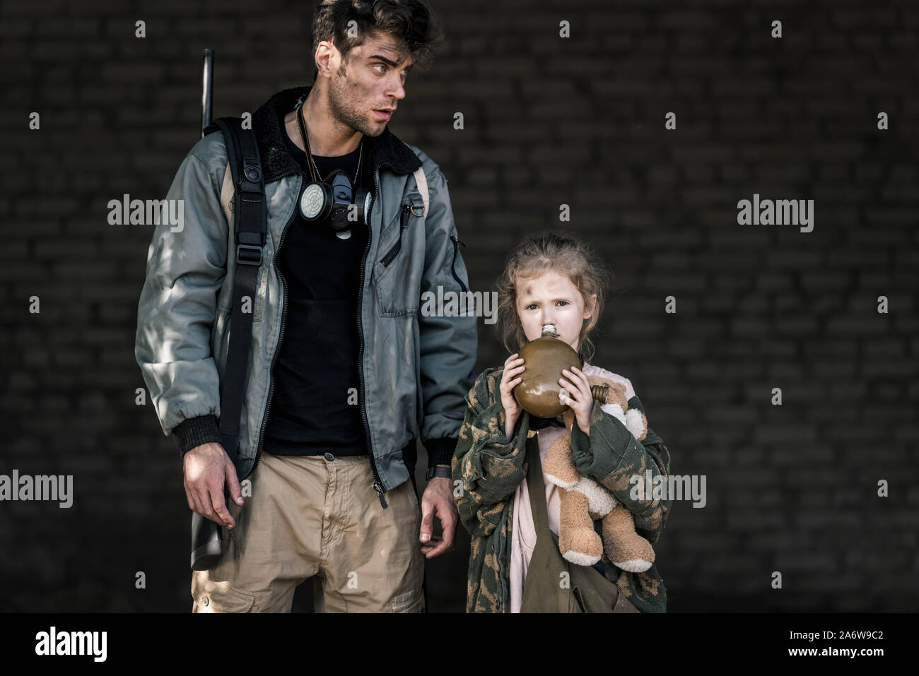 handsome man standing near kid with flask, post apocalyptic concept ...