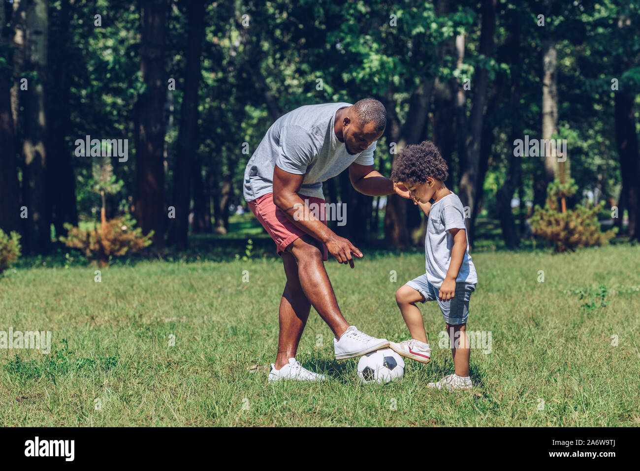 Father teaching son football hi-res stock photography and images - Alamy