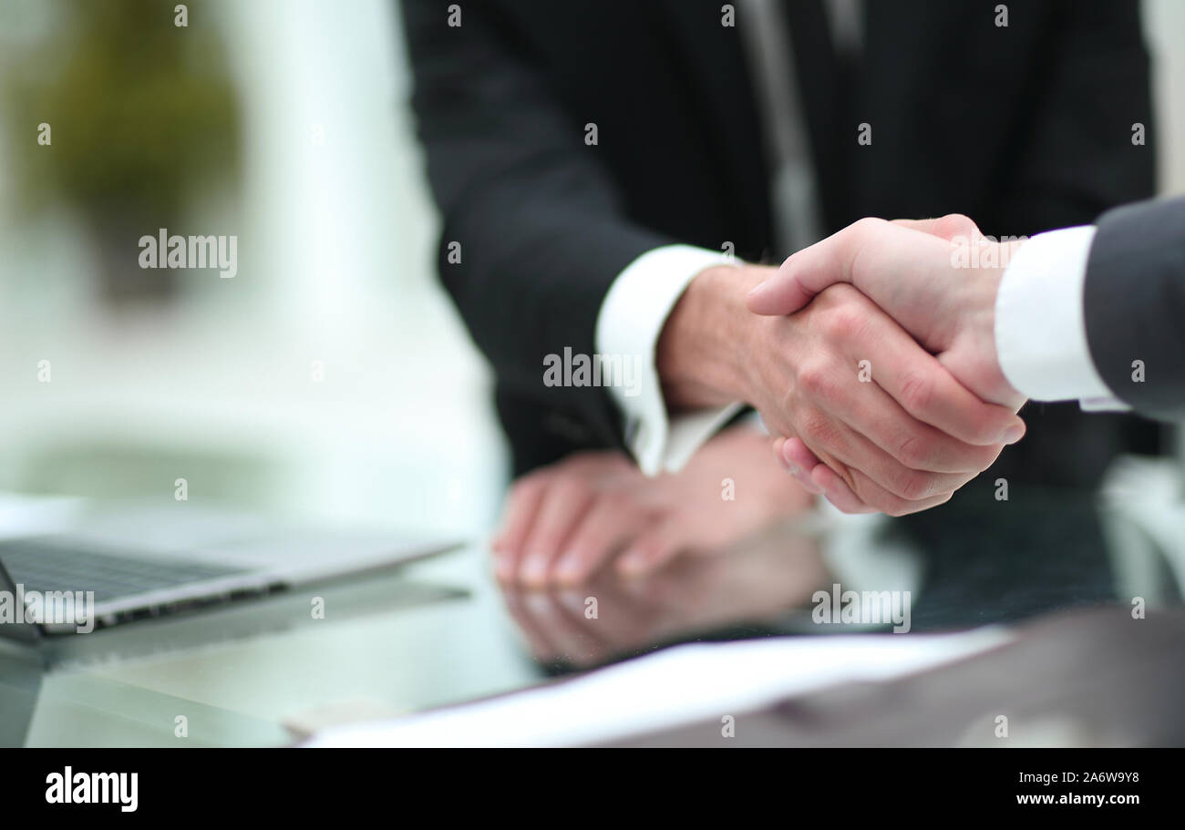 close up. business partners shaking hands at the negotiating table ...