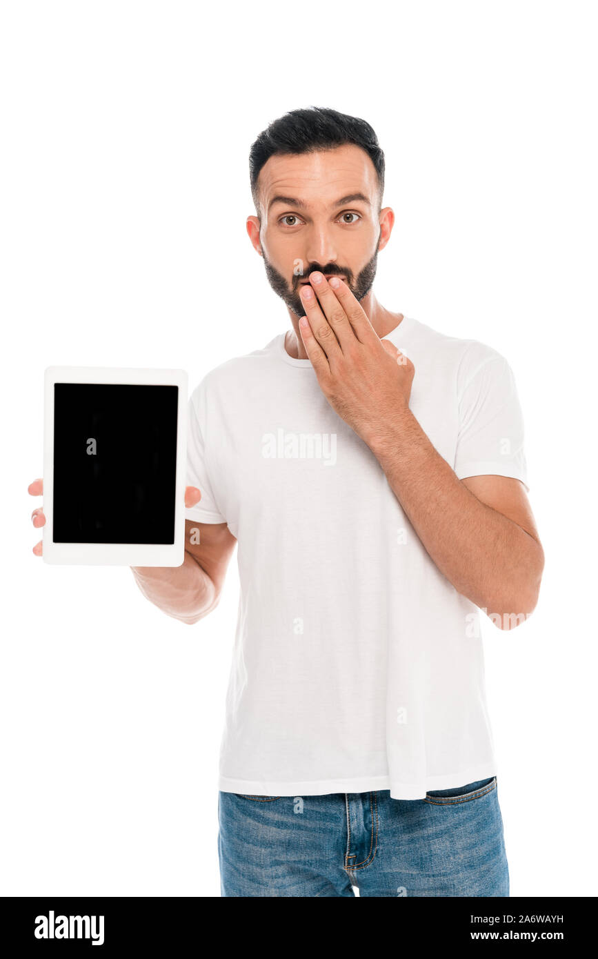 shocked man covering mouth and holding digital tablet with blank screen ...