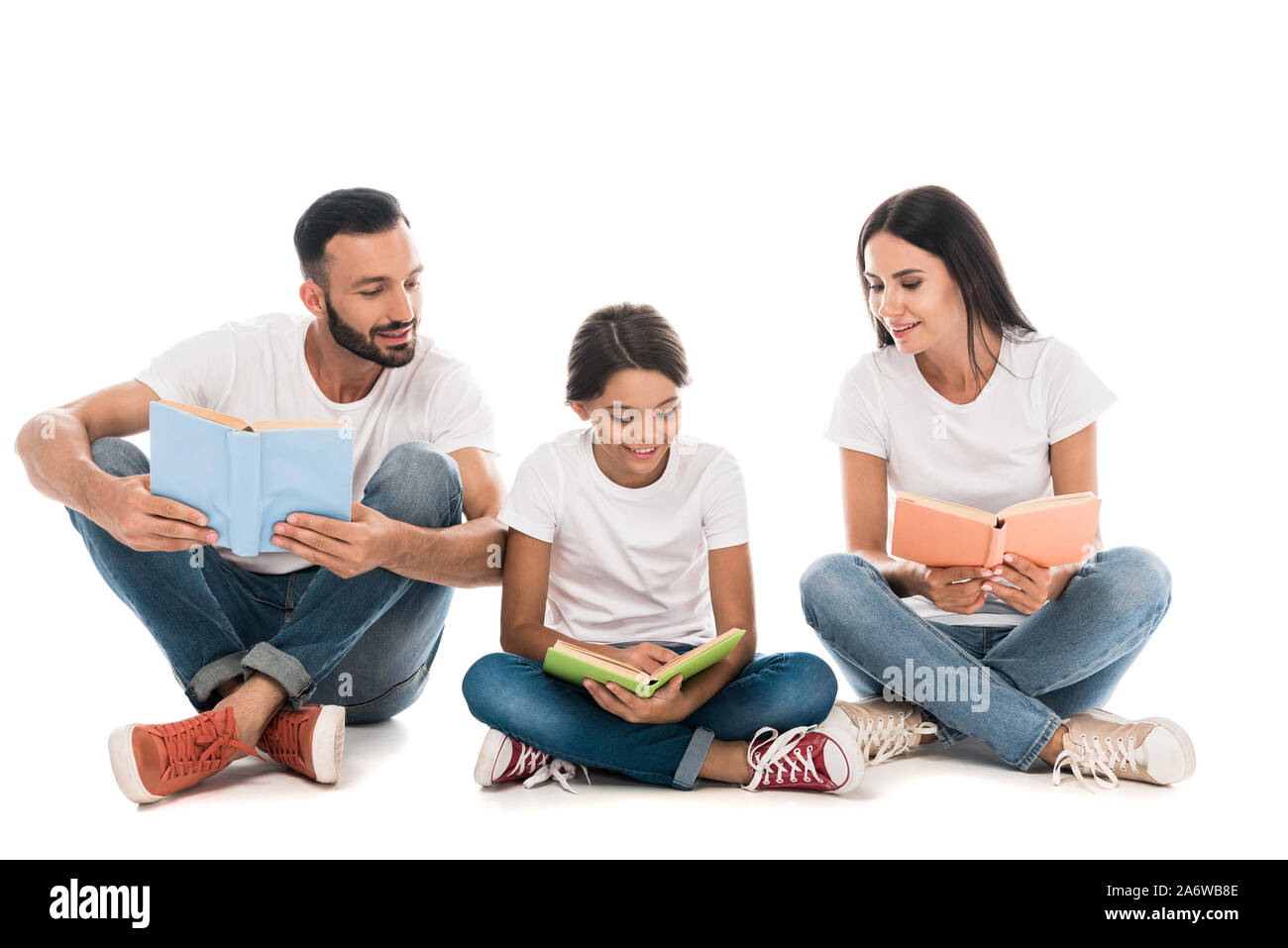 happy family holding books while sitting isolated on white Stock Photo ...