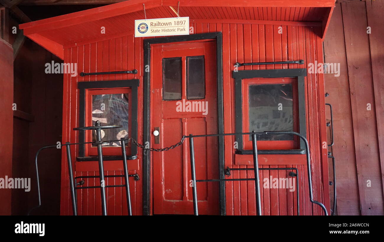Sign: "Railtown 1897 State Historic Park" on preserved red caboose ...