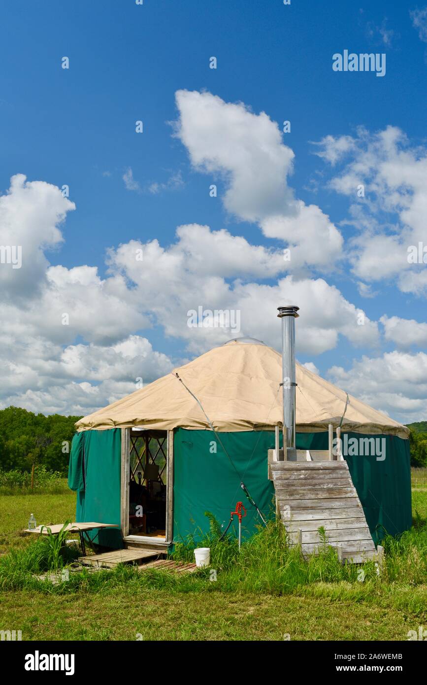 Traditional canvas yurt home with chimney at a small farm outside ...