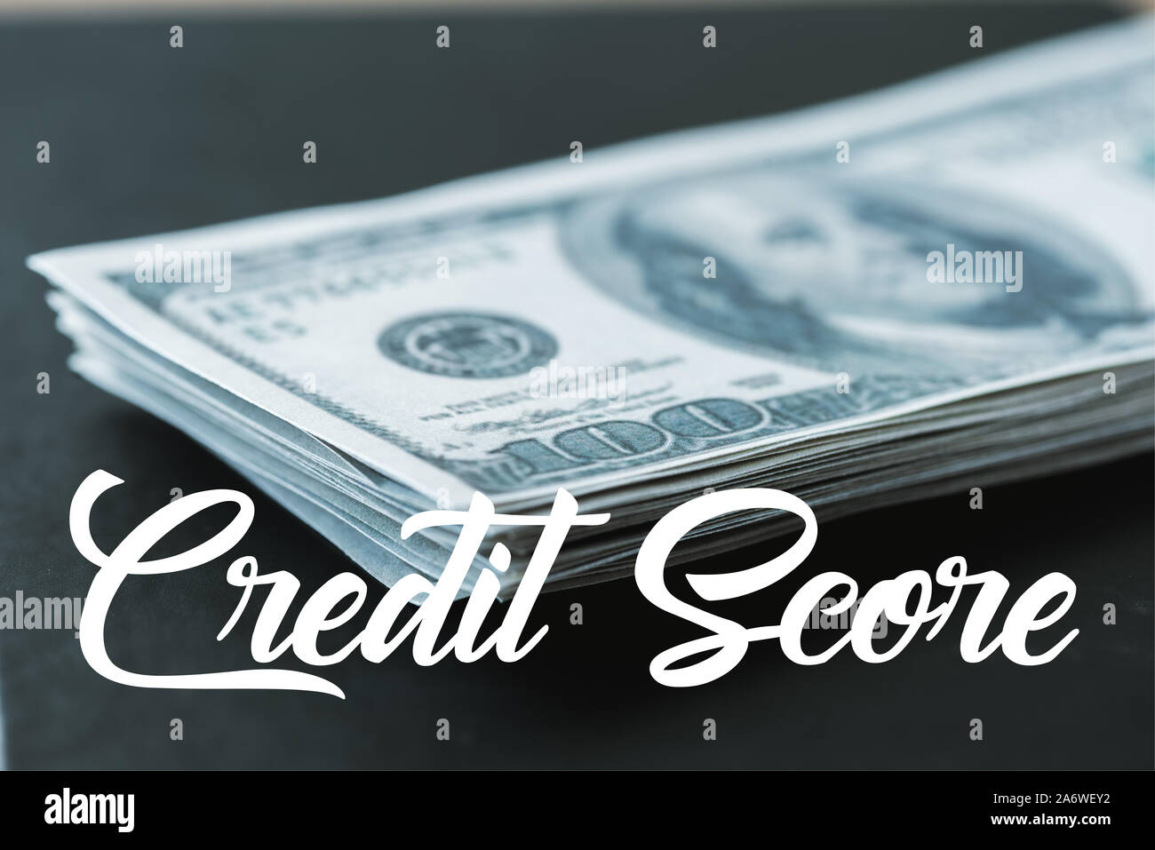 selective focus of stack with dollar banknotes near credit score ...