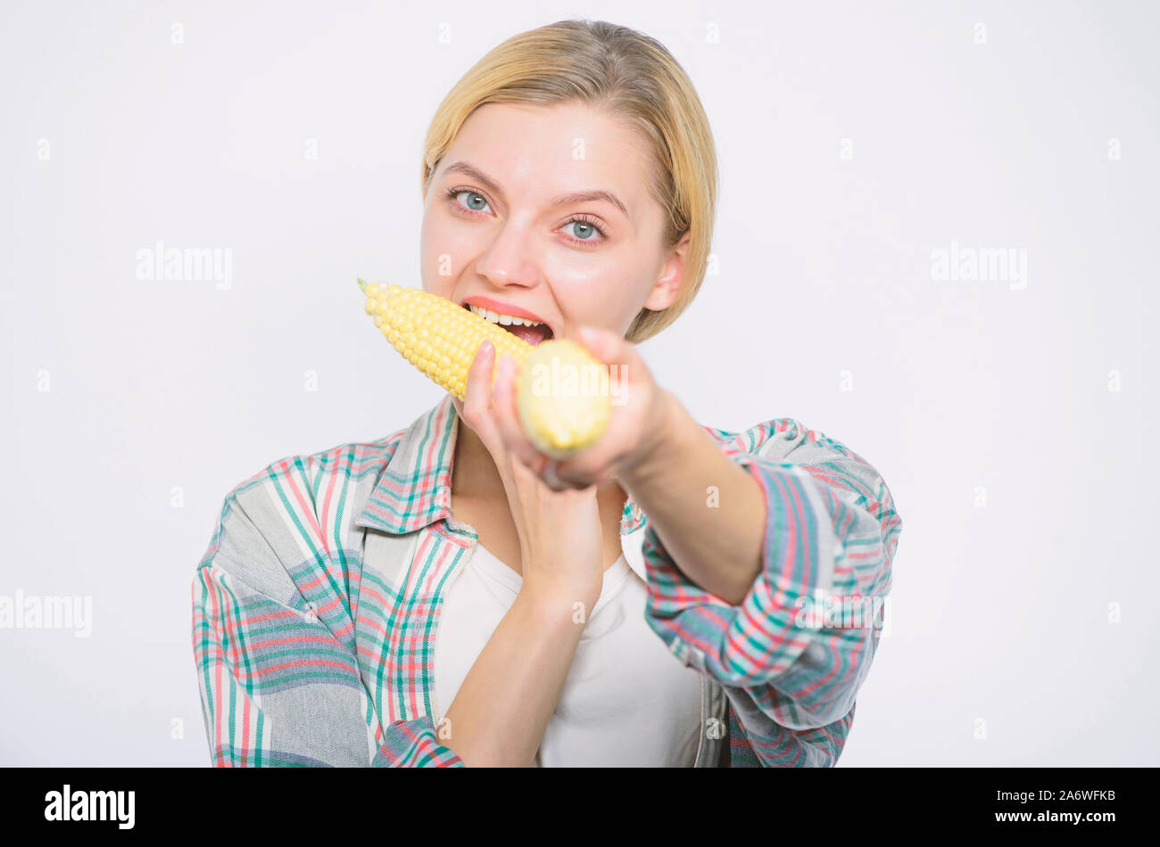 woman eating a delicious corncob. Happy woman eating corn. vegetable ...