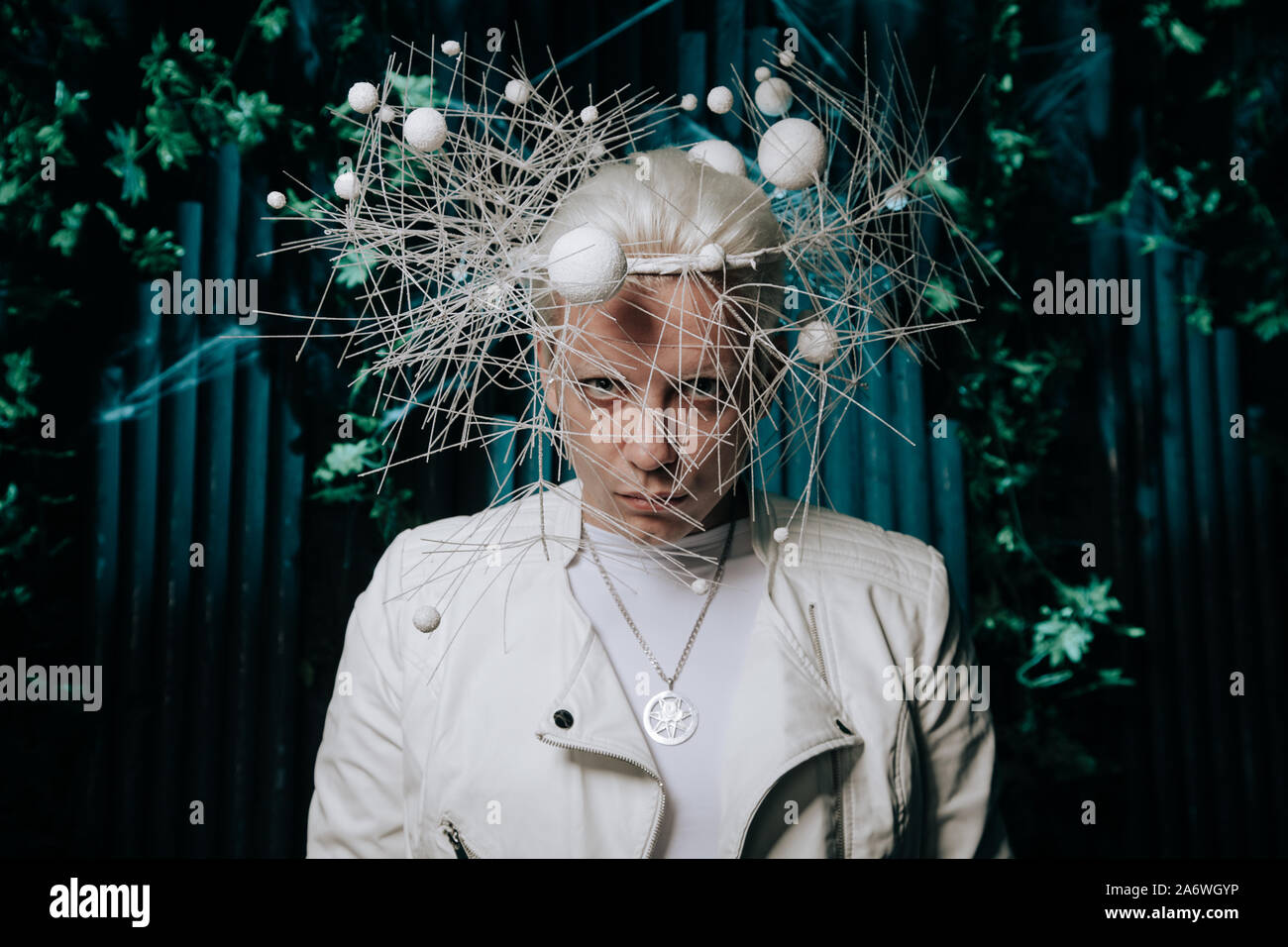 unusual man wearing a strange hat. space headdress in the form of balls ...