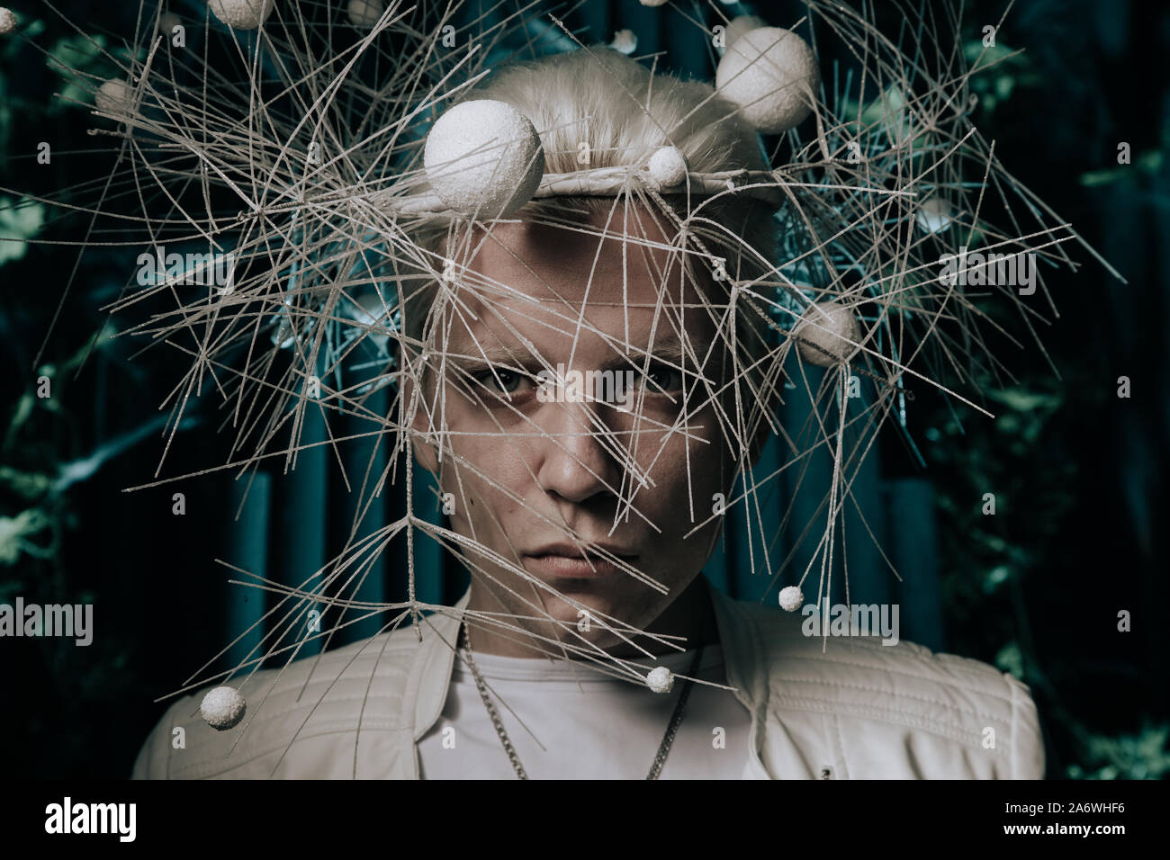 unusual man wearing a strange hat. space headdress in the form of balls ...