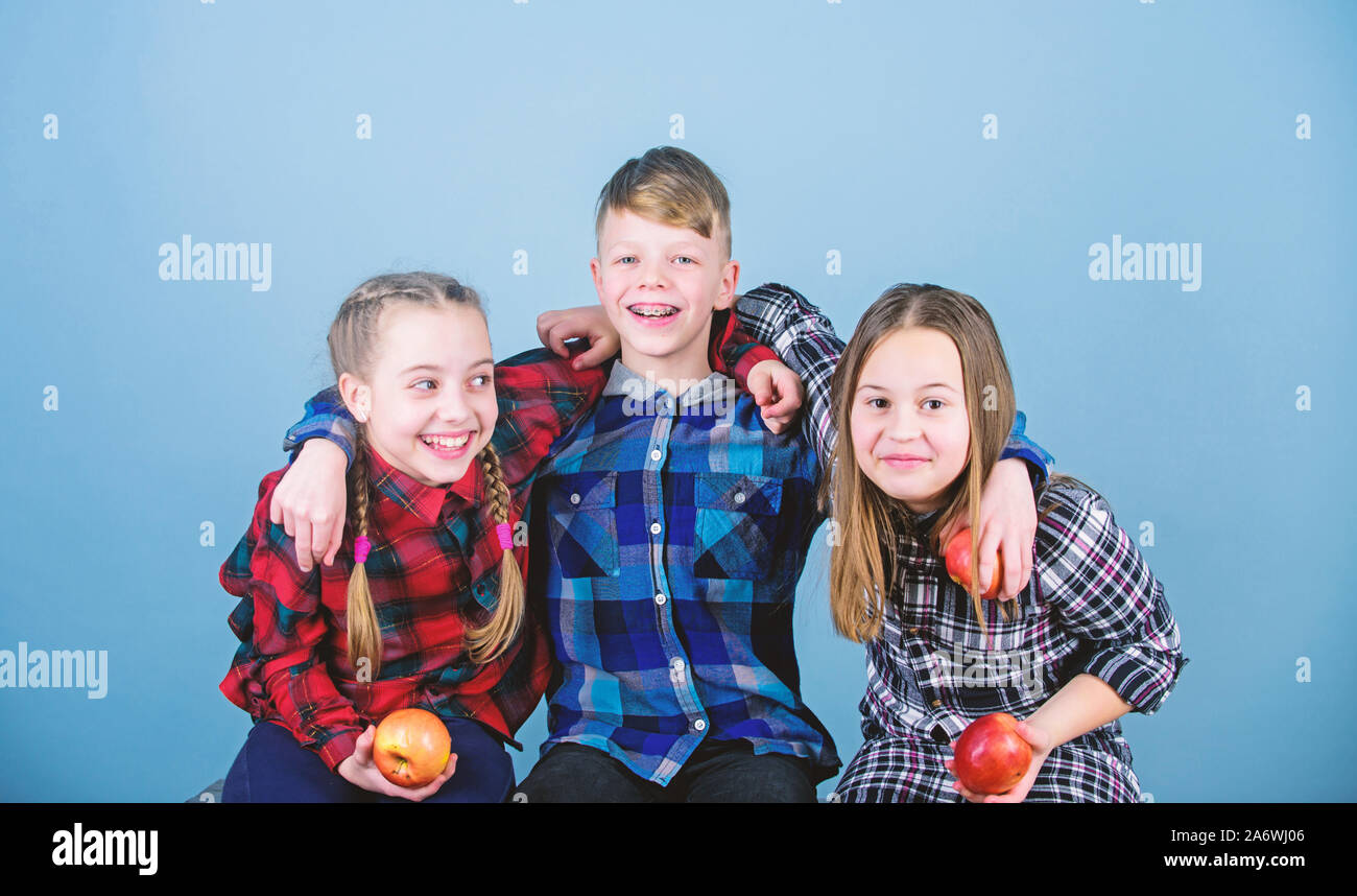 Leading a fruitful life. Little children holding red apples. Small ...