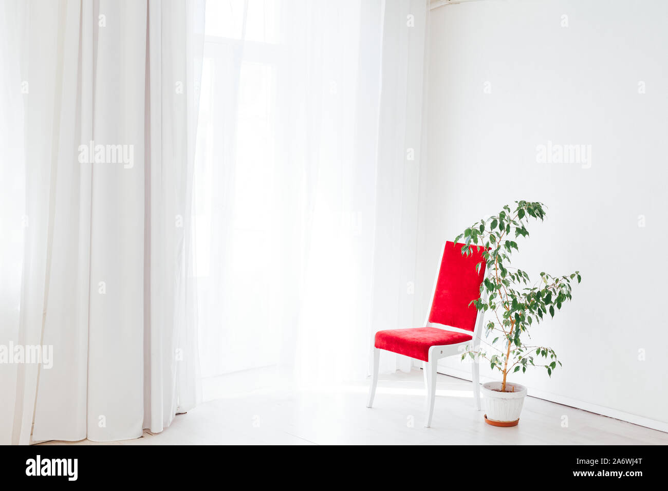 red chair in the interior of an empty white room Stock Photo - Alamy