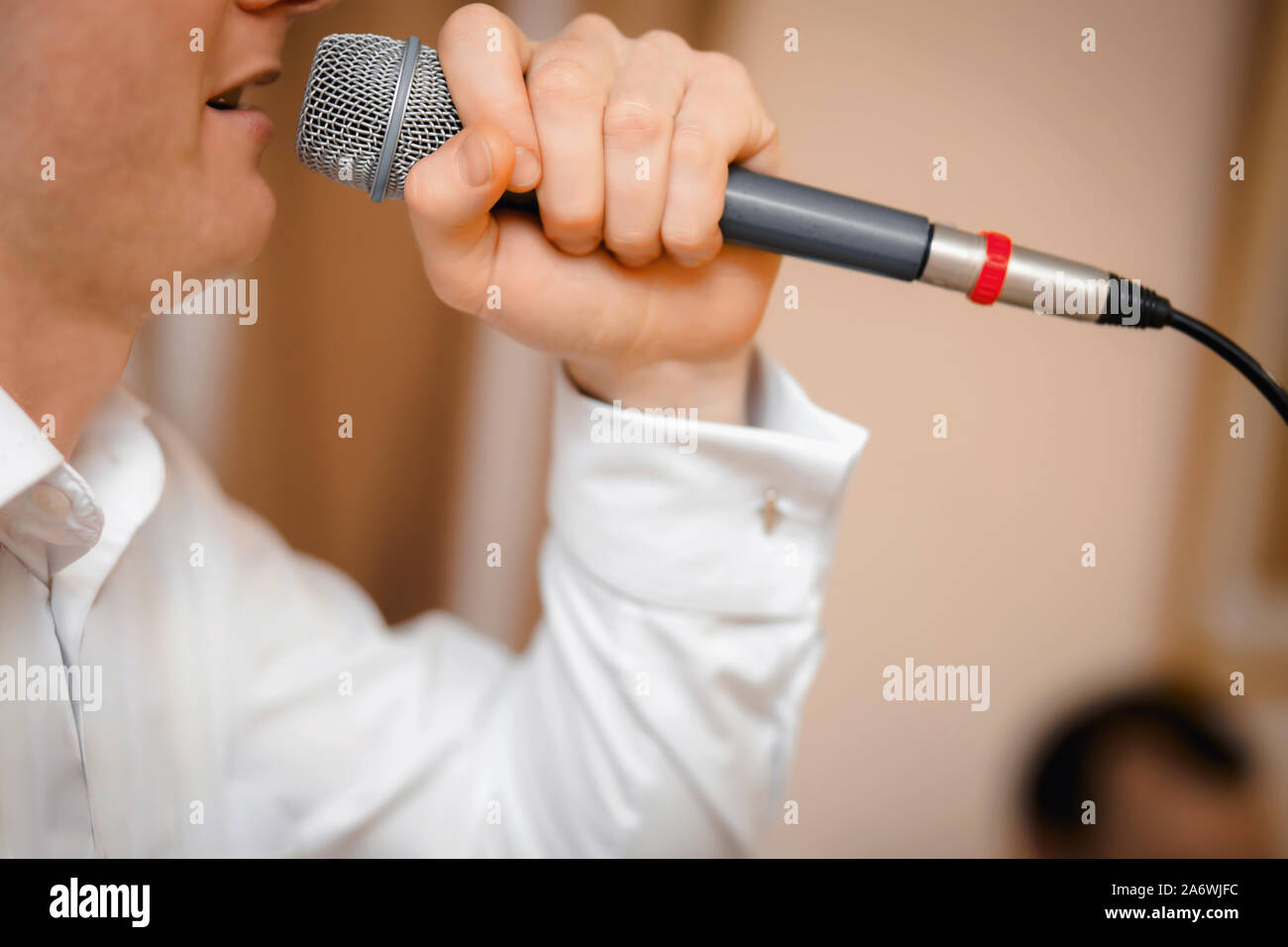 Close-up Guy singing into the microphone close-up. Profile of ...