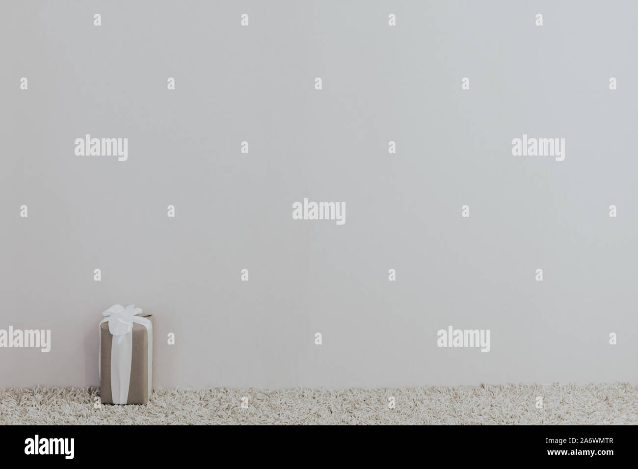 one gray birthday present on a grey background Stock Photo - Alamy