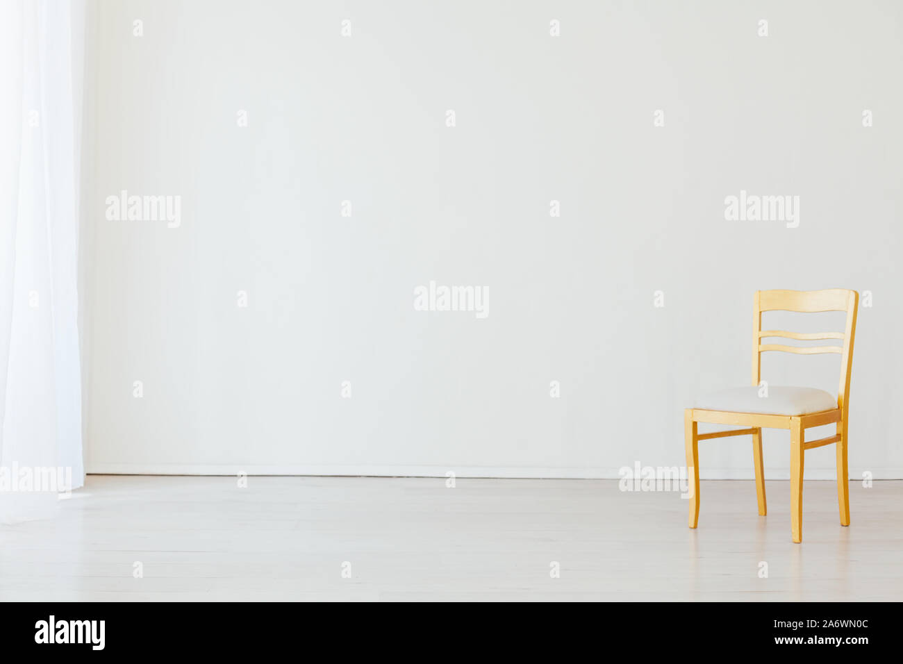 one old vintage chair in an empty white room Stock Photo - Alamy