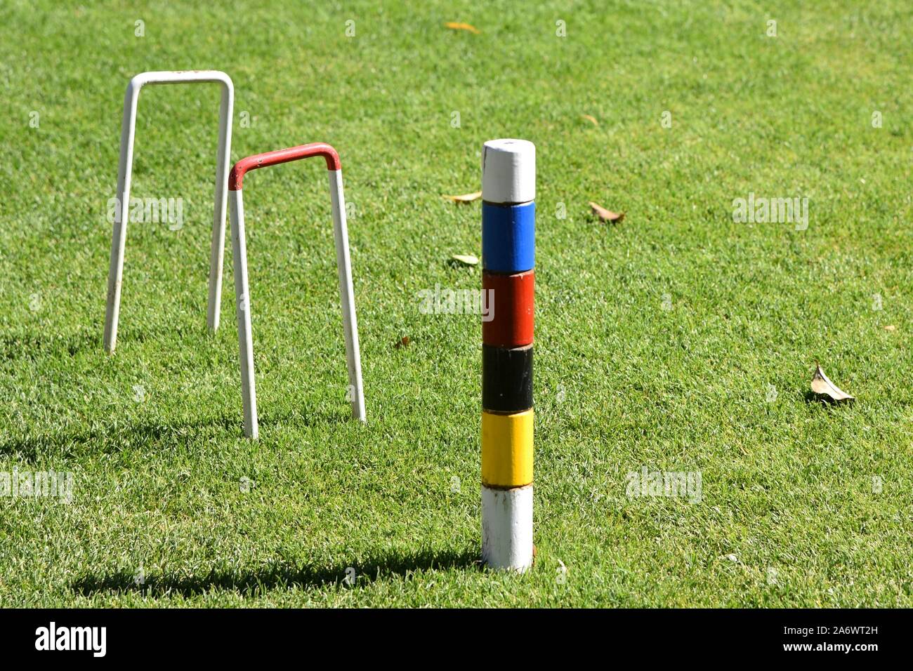Croquet wickets and colors in the grass Stock Photo - Alamy