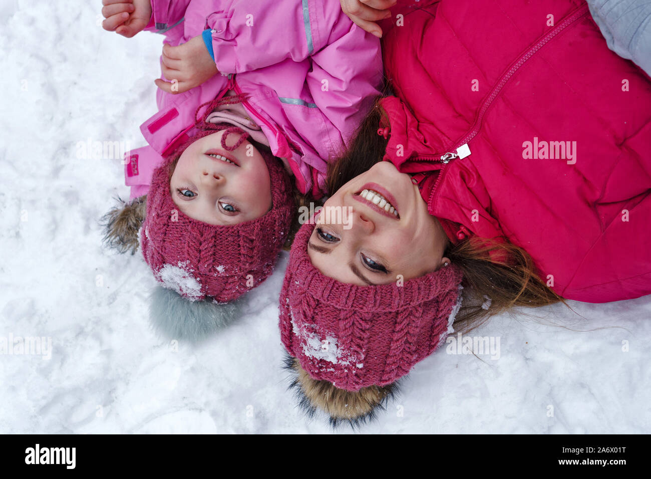 Fashionable stylish family having fun playing in snow. Weekends ...