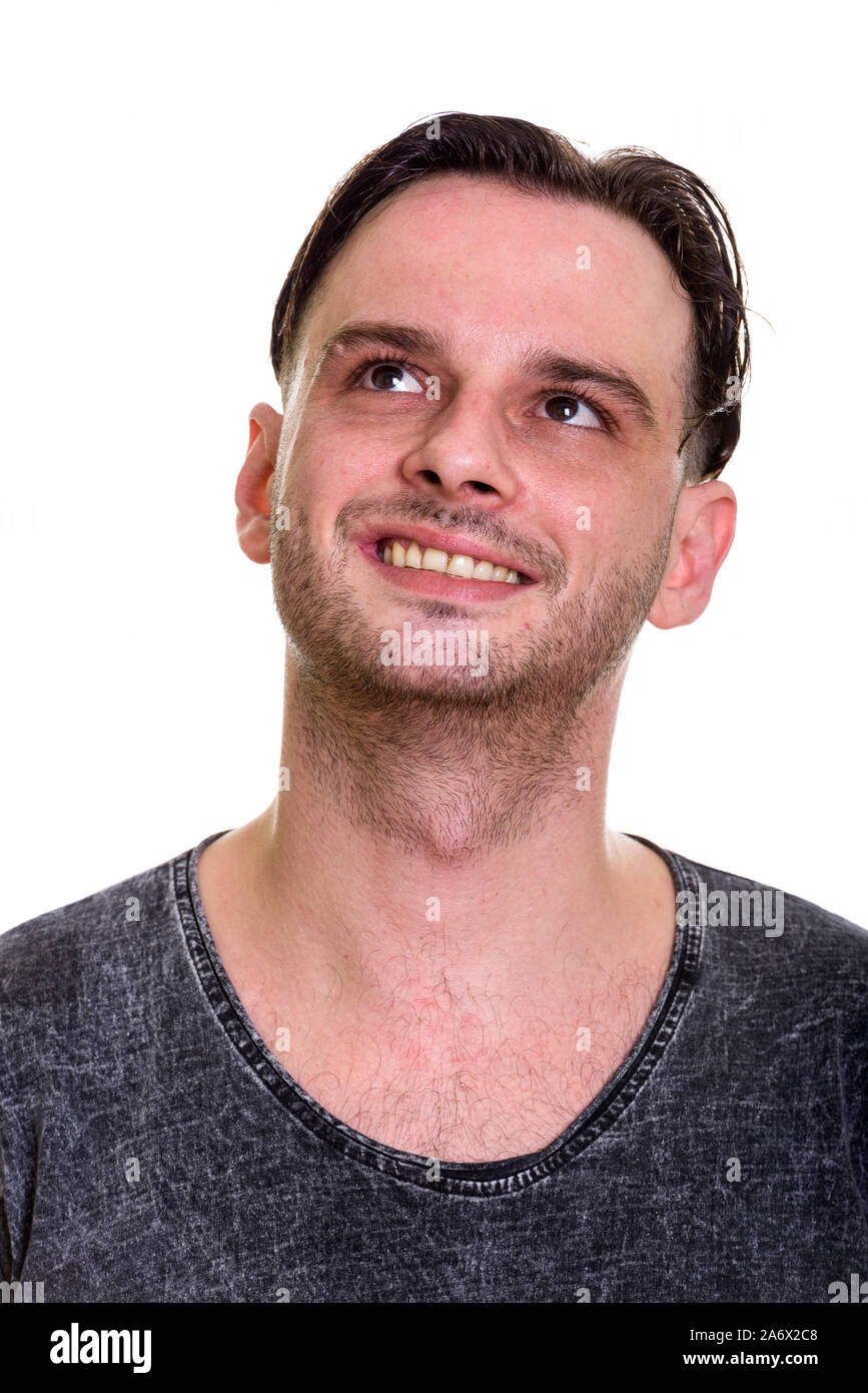 Face of young happy man smiling while thinking Stock Photo - Alamy