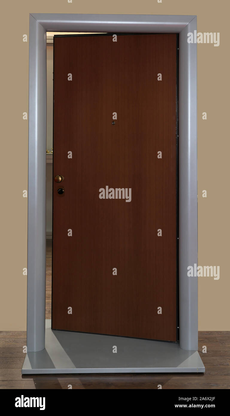 Slightly open wooden door inside home interior Stock Photo - Alamy
