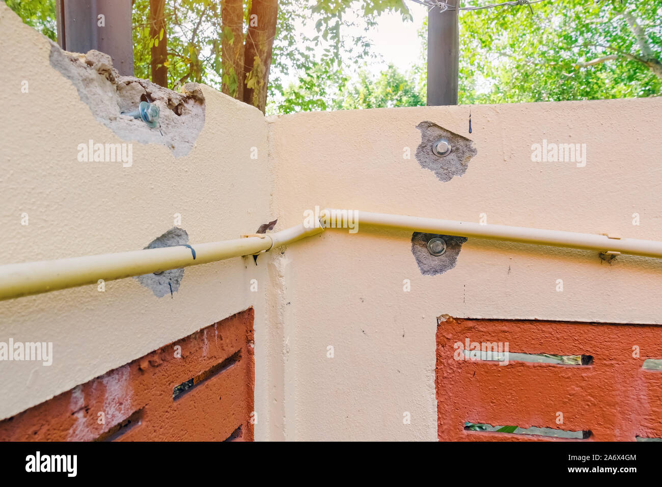 Broken on concrete walls after drilling and fixing bolt with nut and ...