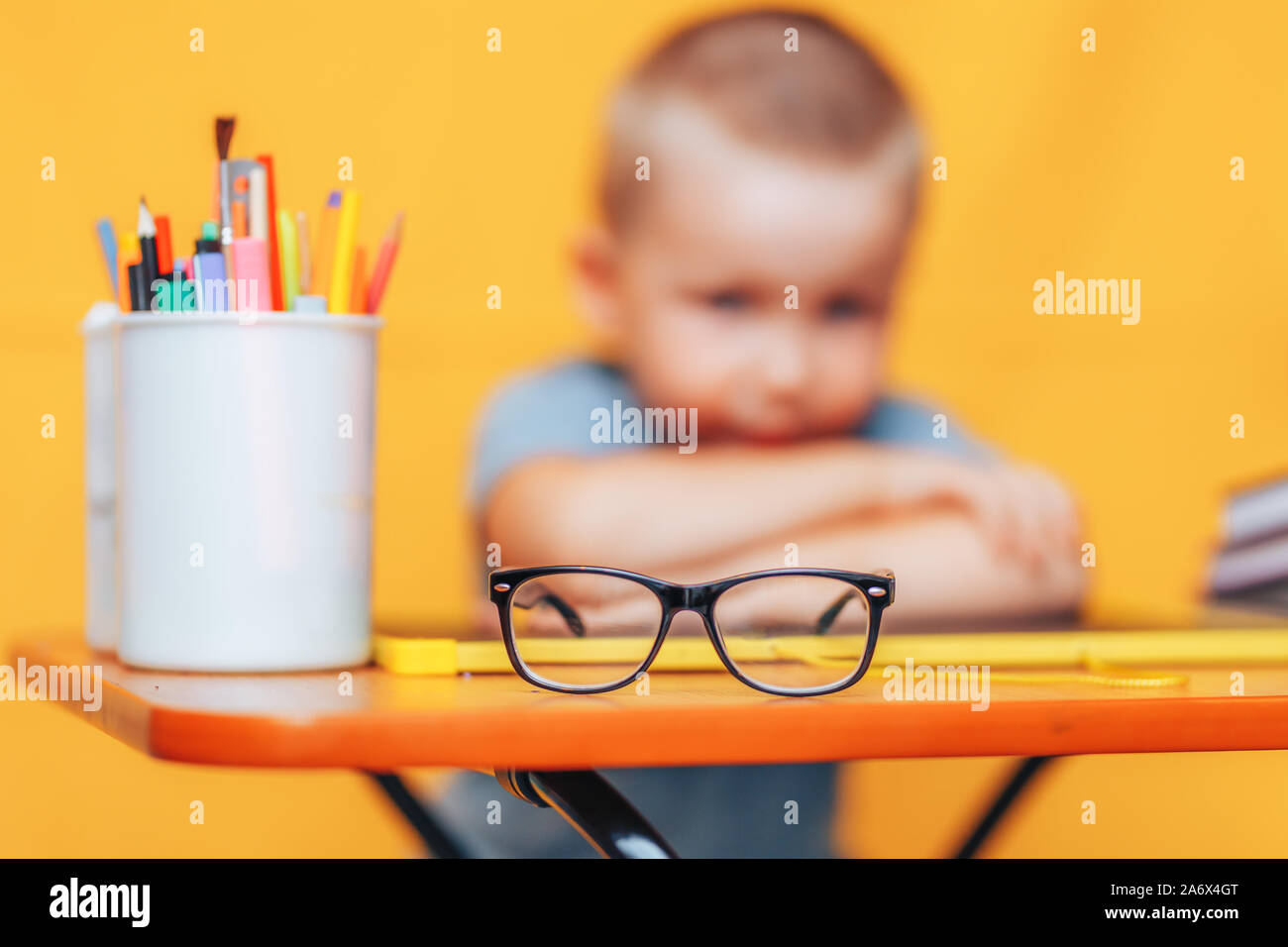 boy sitting ubfocused glasses in focus. Concept problem of ...