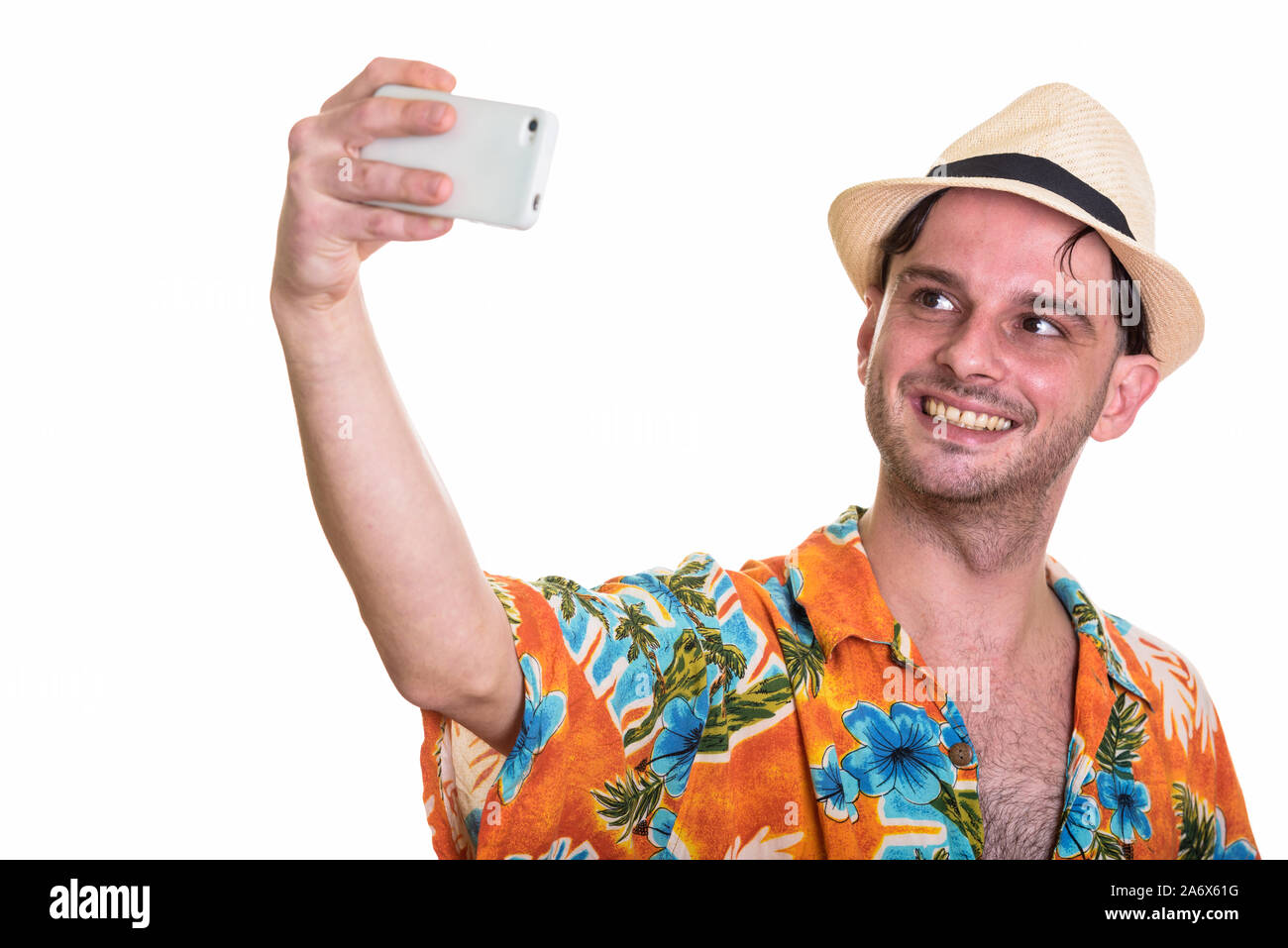 Studio shot of young happy man smiling while taking selfie with Stock ...