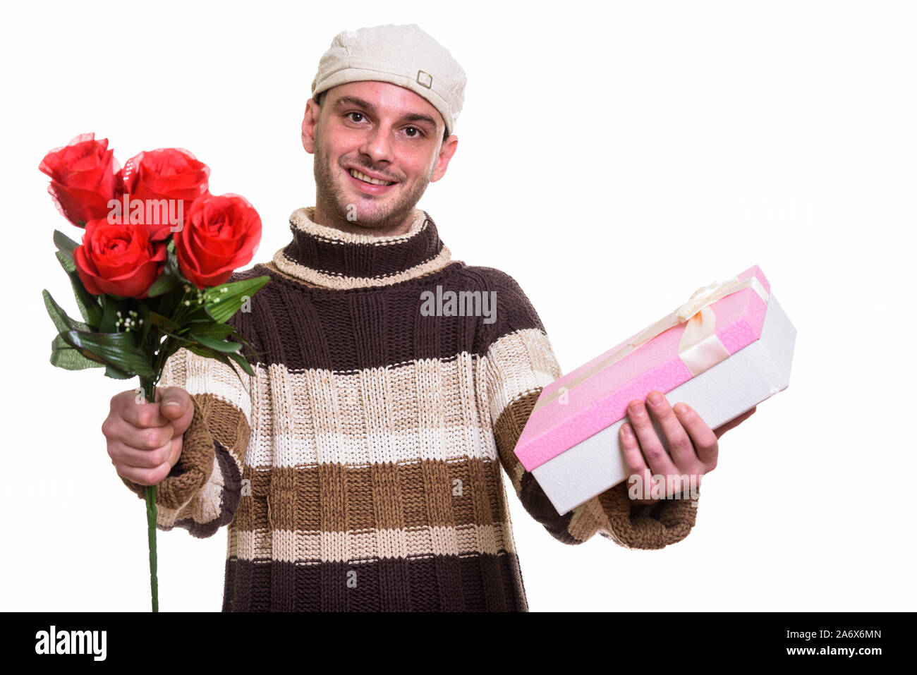 Studio shot of young happy man smiling while giving red roses an Stock ...