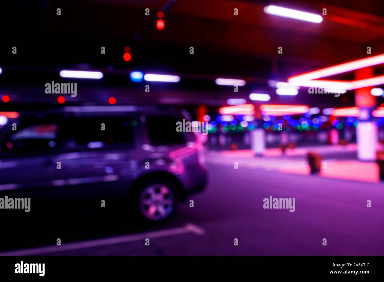 Blurred cars in car parking lot in shopping mall. Bokeh lights ...