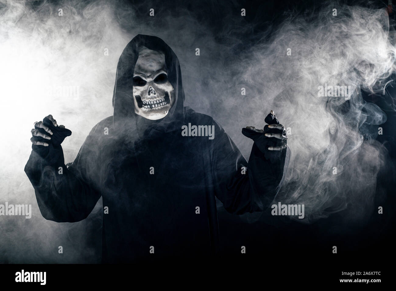 Scary looking grim reaper ghost coming out of the foggy mist. The ...