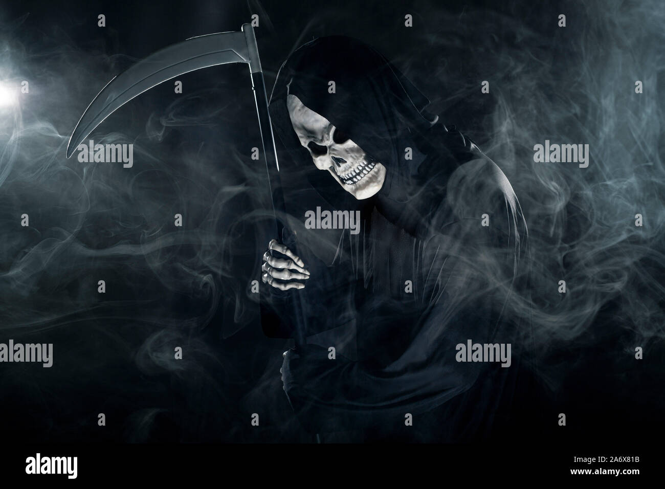 Scary looking grim reaper ghost wielding a scythe or sickle coming out ...