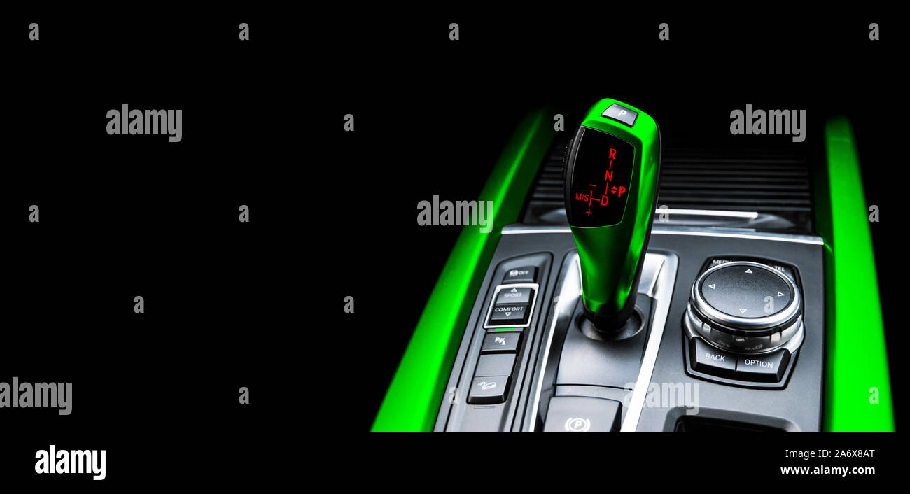 Green Automatic gear stick of a modern car. Maodern car interior details. Close up view. Car ...