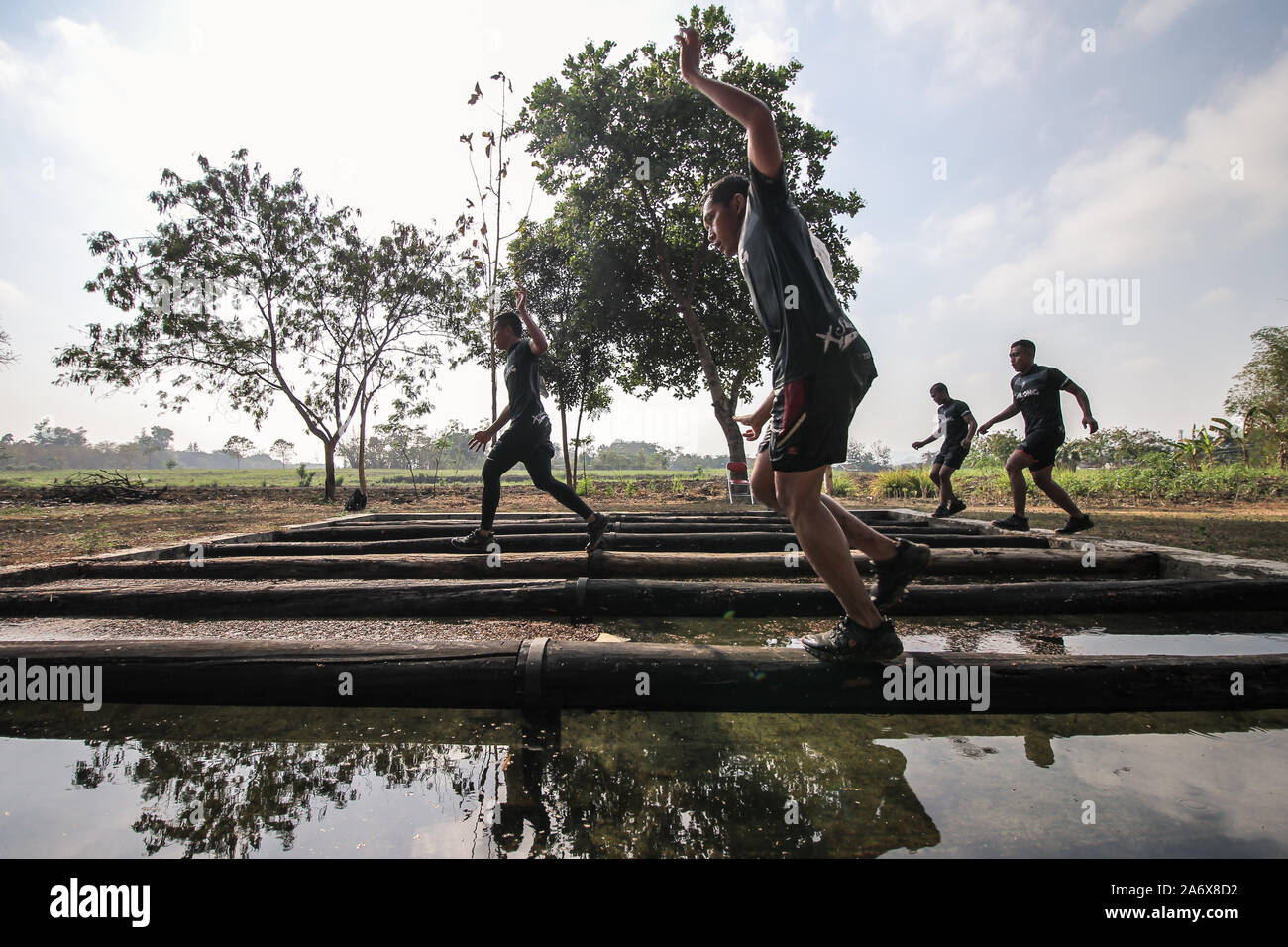 Asian people race trail running through a karst river Stock Photo - Alamy