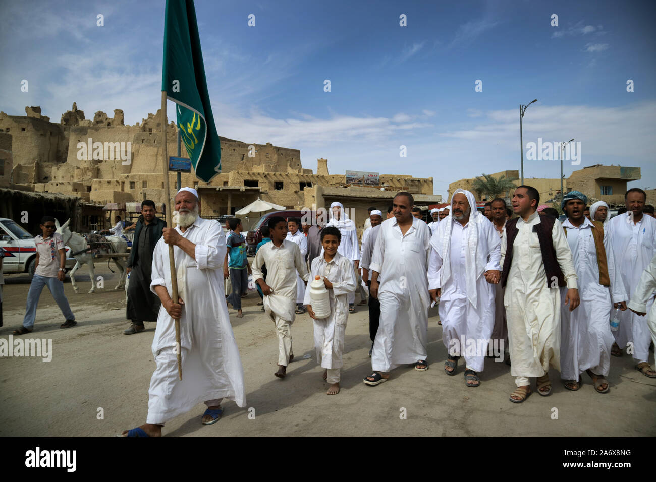 Siwan people holding a giant green flag, march ahead of the Shali ...