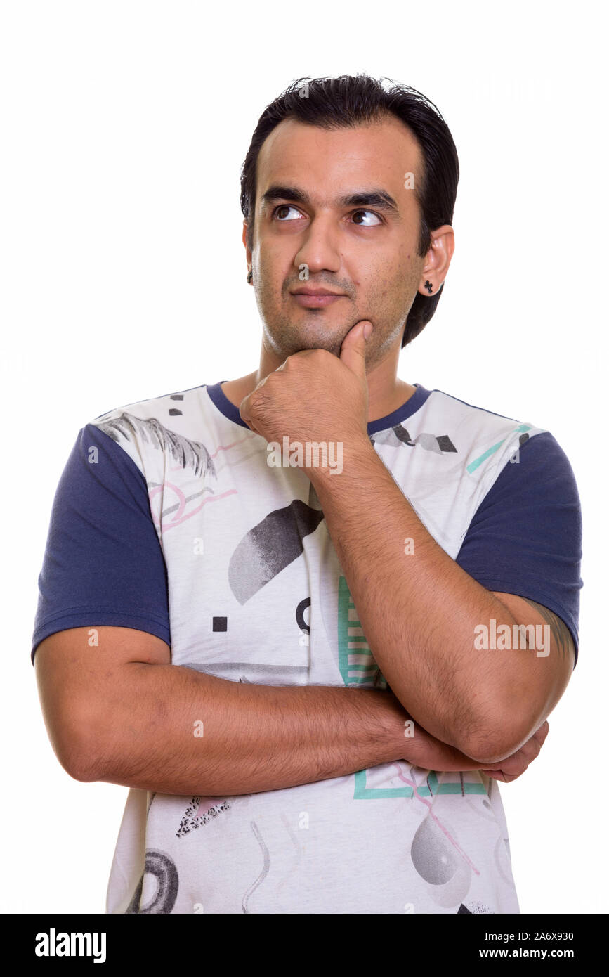 Studio shot of Persian man thinking while looking up Stock Photo - Alamy