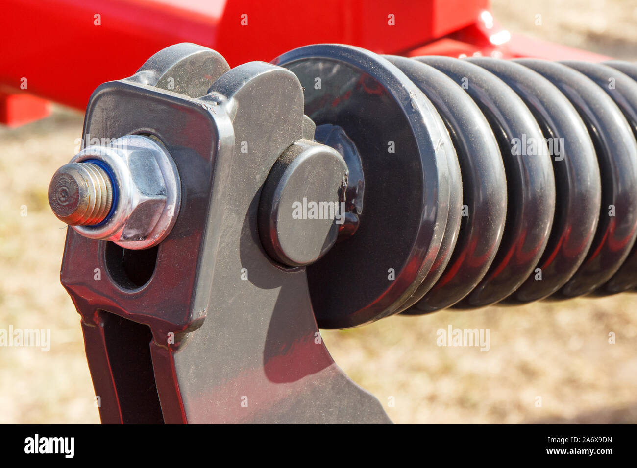 Steel spring in industrial or agricultural machinery. Part of hydraulic ...
