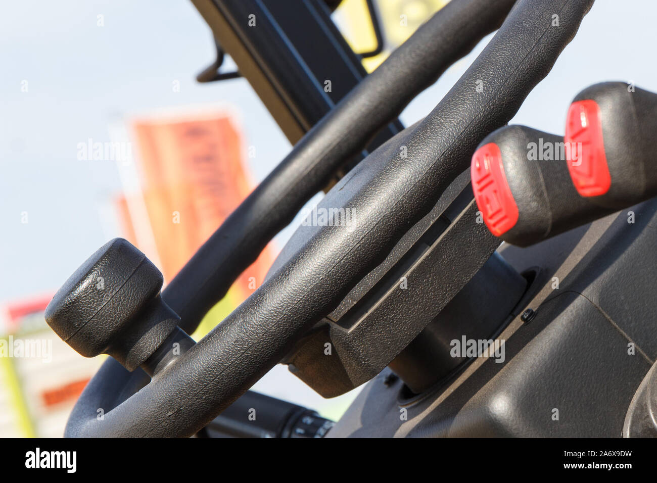 Operating control levers and steering wheel in loader machine or other ...