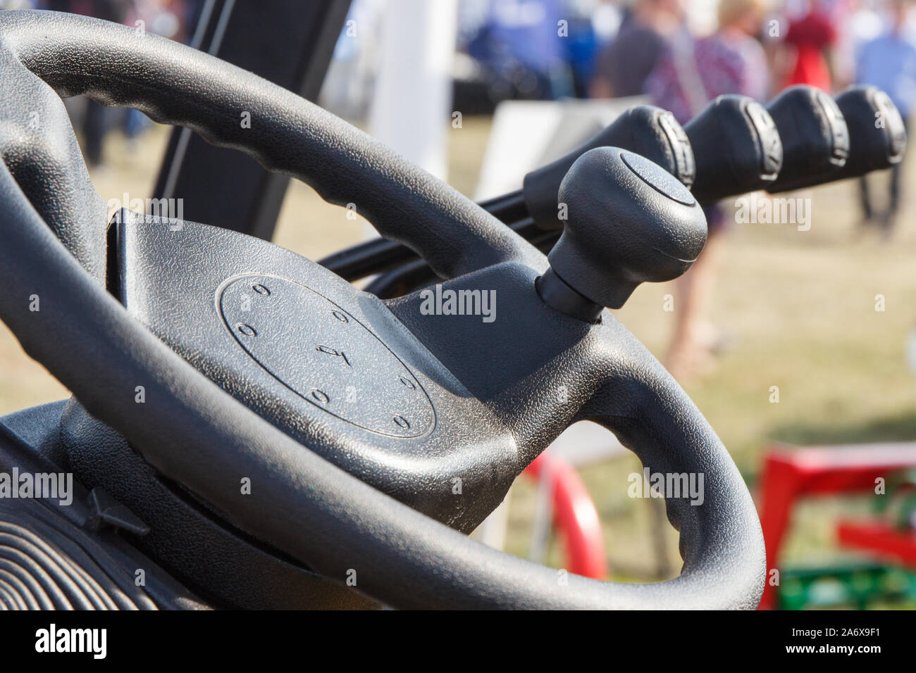 Steering wheel and operating control levers in loader machine or other ...