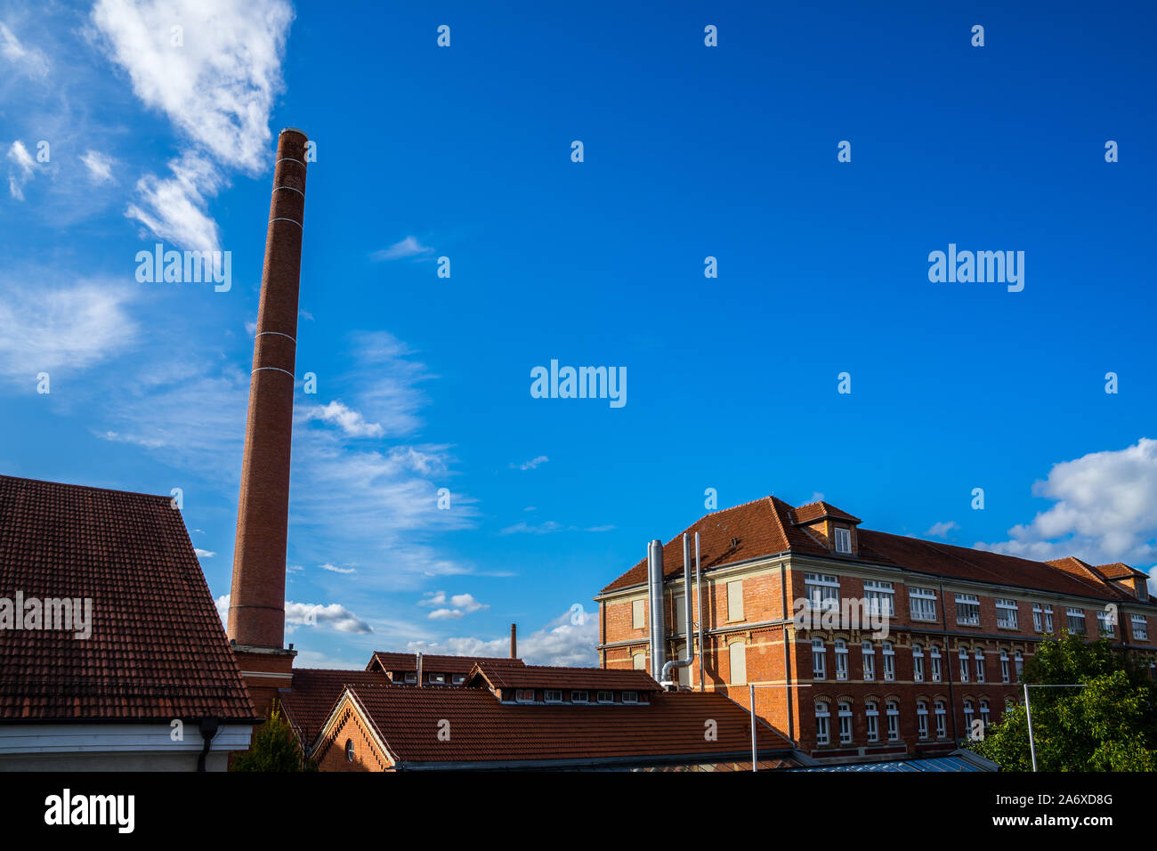 Germany, Ancient historical red brick buildings and tall chimney in ...