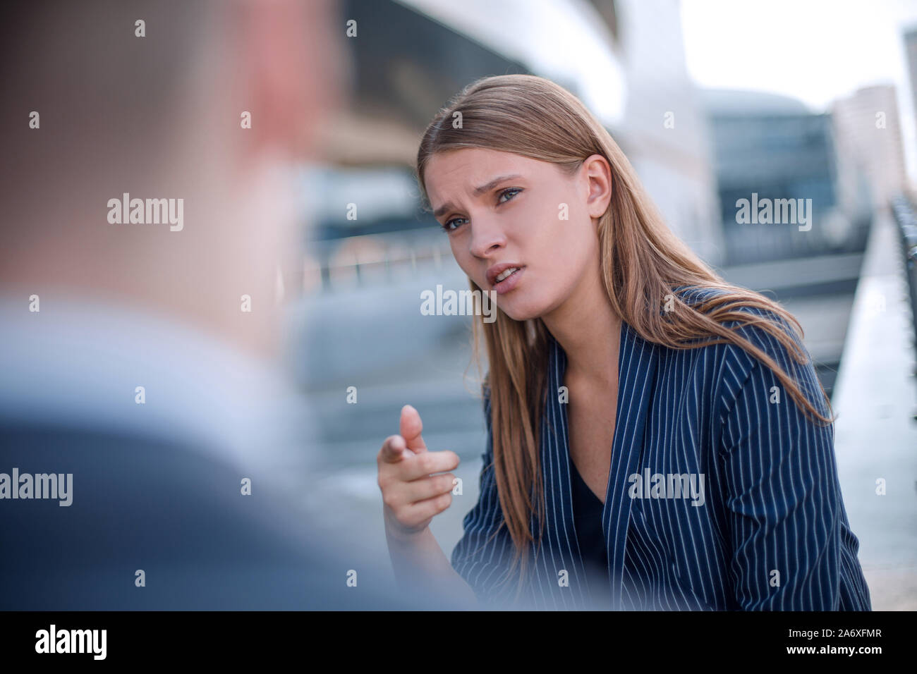 serious young woman asking something of her interlocutor Stock Photo ...