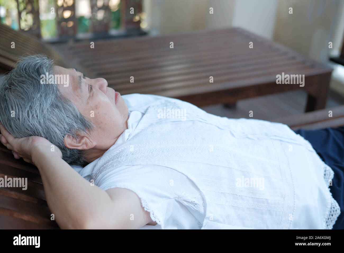 old elderly elder senior woman feet resting relaxing on terrace balcony ...