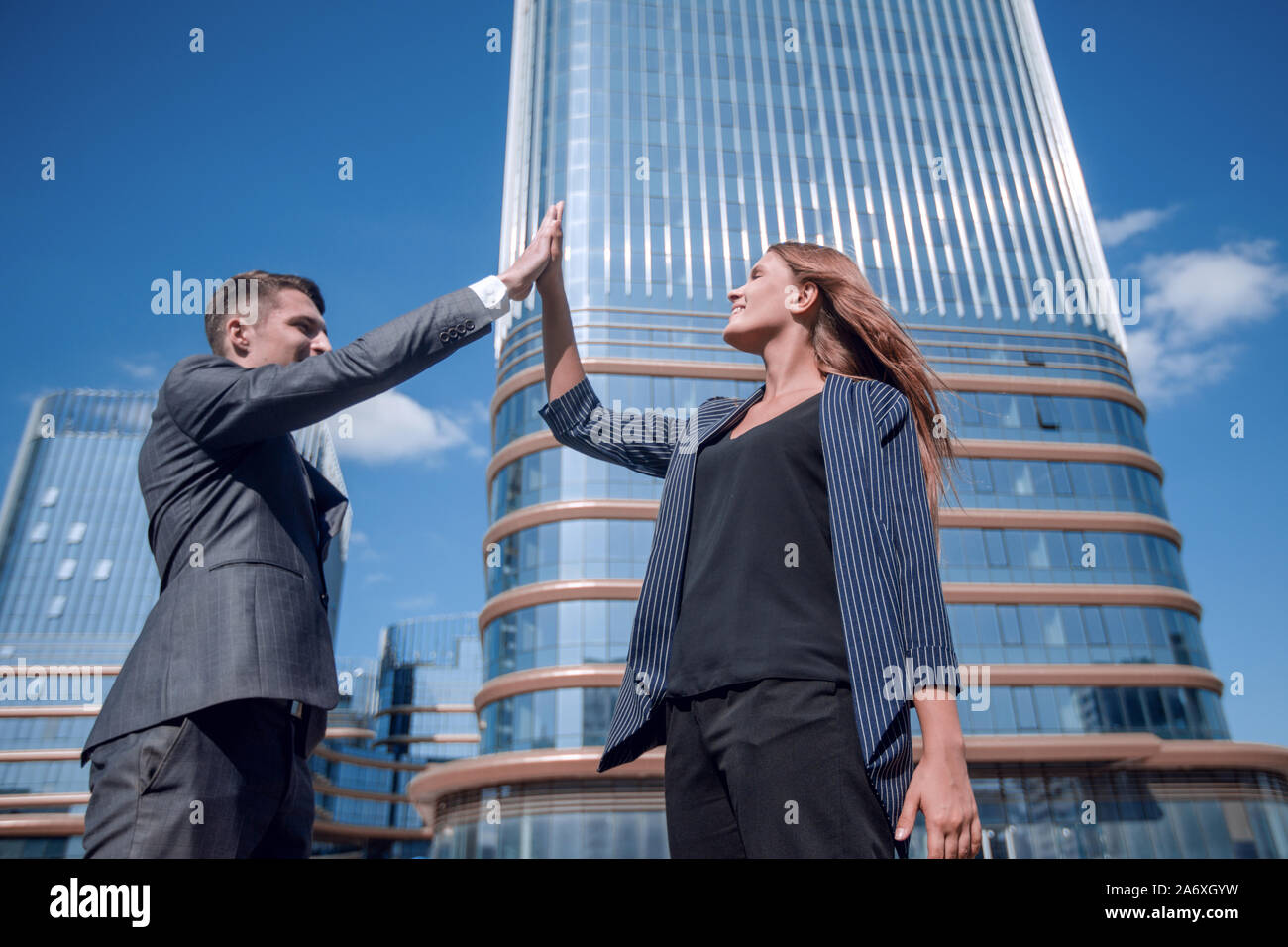young business partners giving each other a high five Stock Photo - Alamy