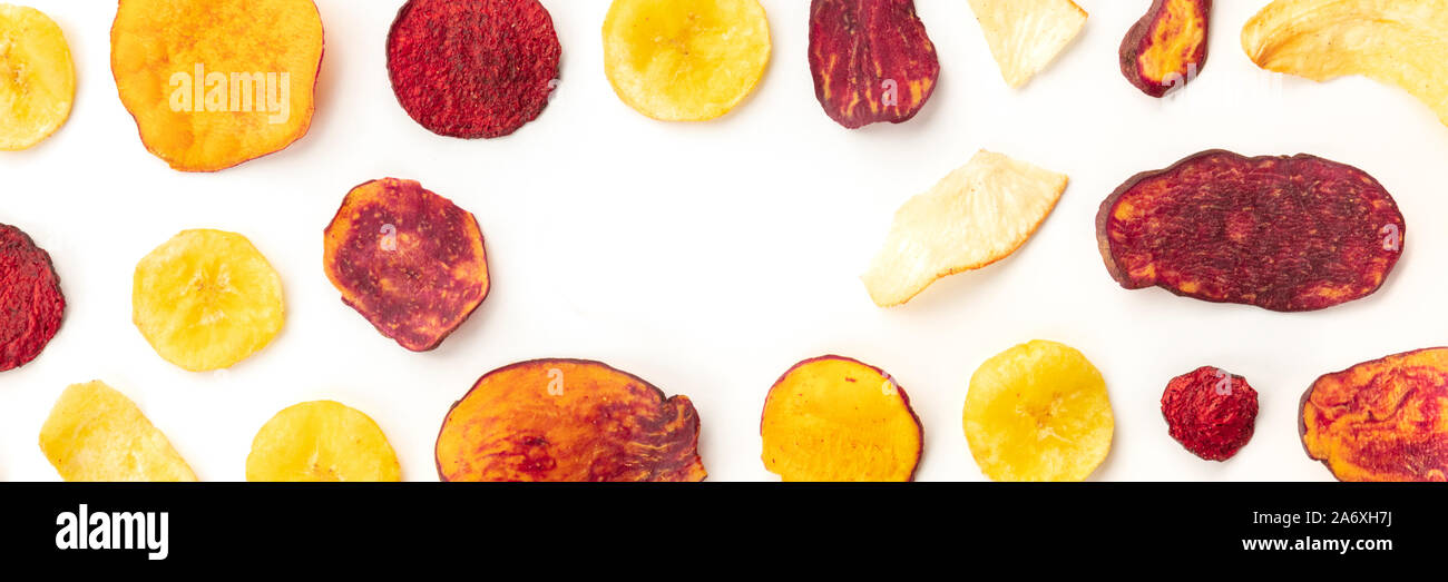 A panorama of dry fruit and vegetable crisps, healthy vegan snack, on a ...