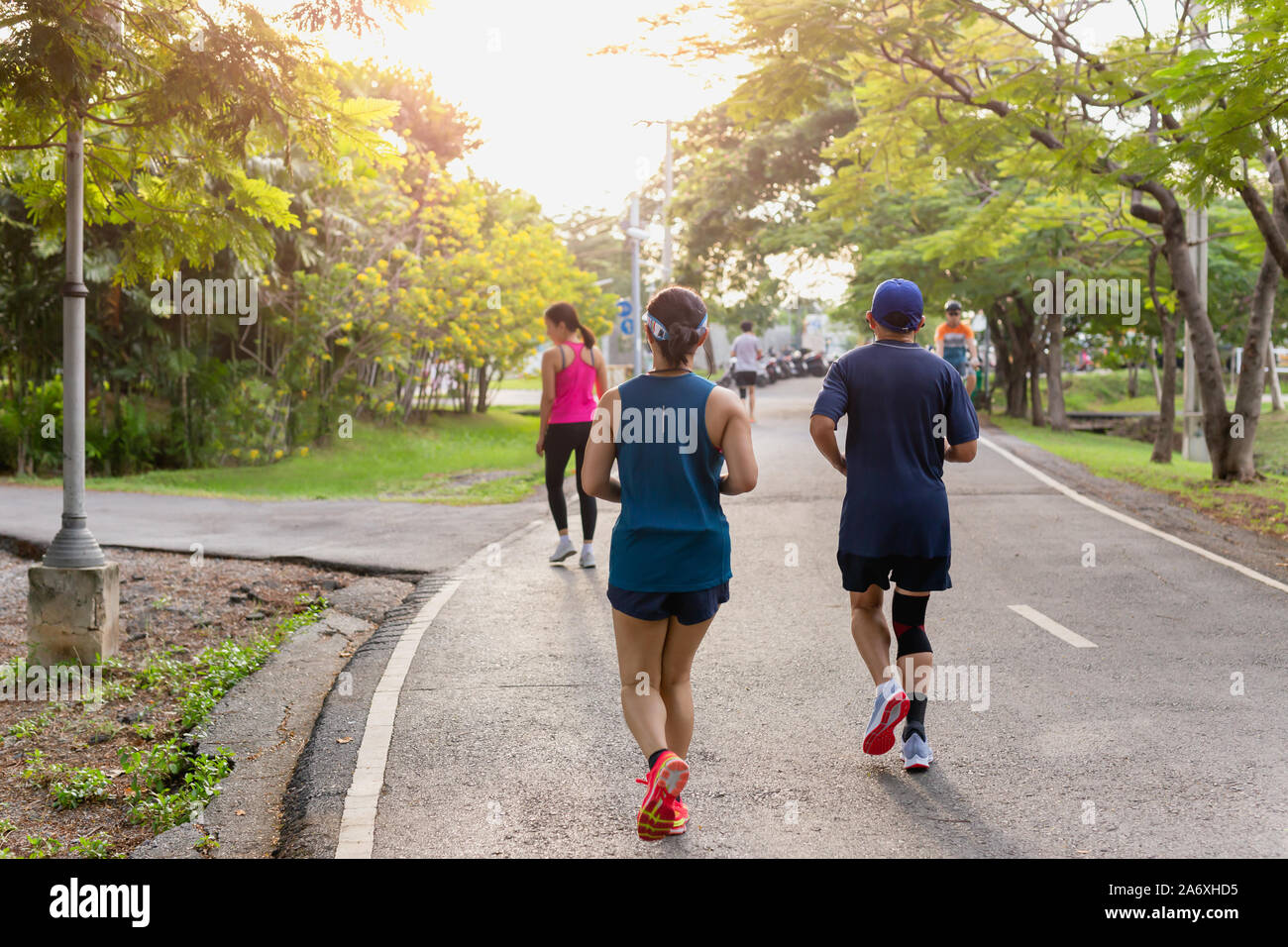 People jogging exercise in the park in morning sunrise Stock Photo - Alamy