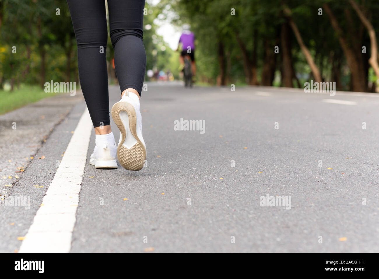 Woman legs walking road close hi-res stock photography and images - Alamy