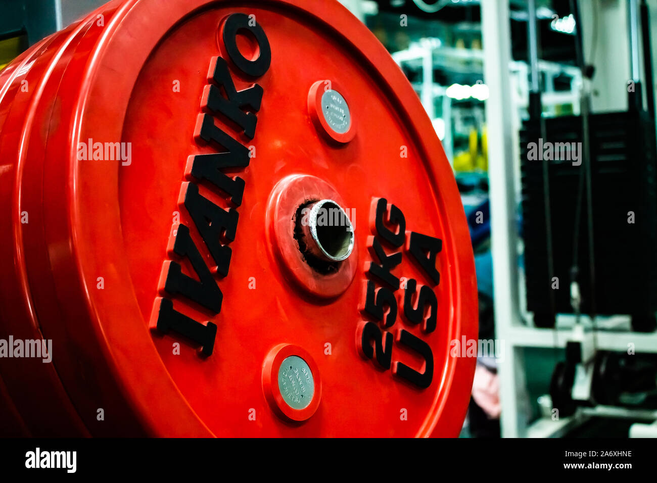 Professional red dumbbells and weight plate on the background of a ...