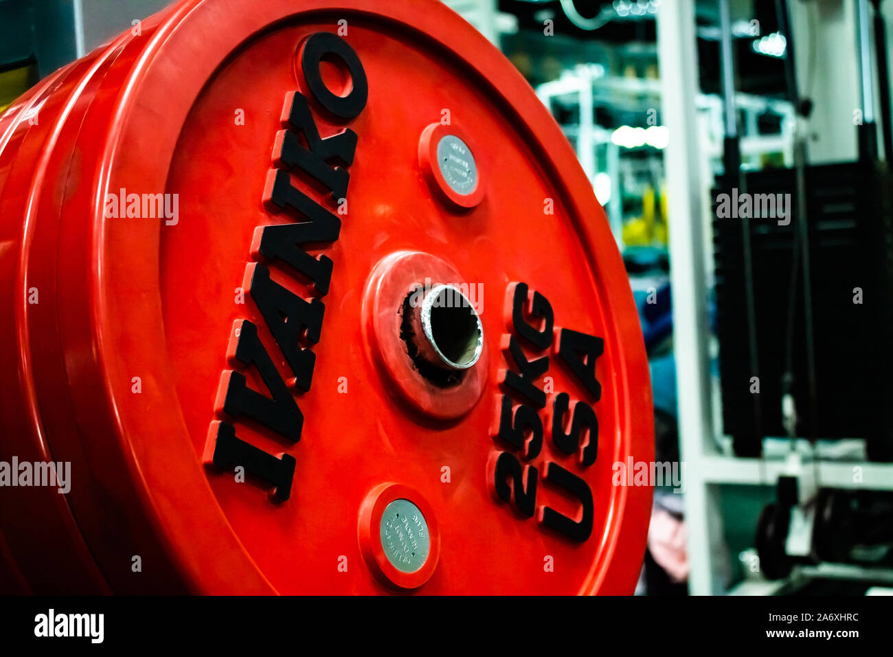 Professional red dumbbells and weight plate on the background of a ...