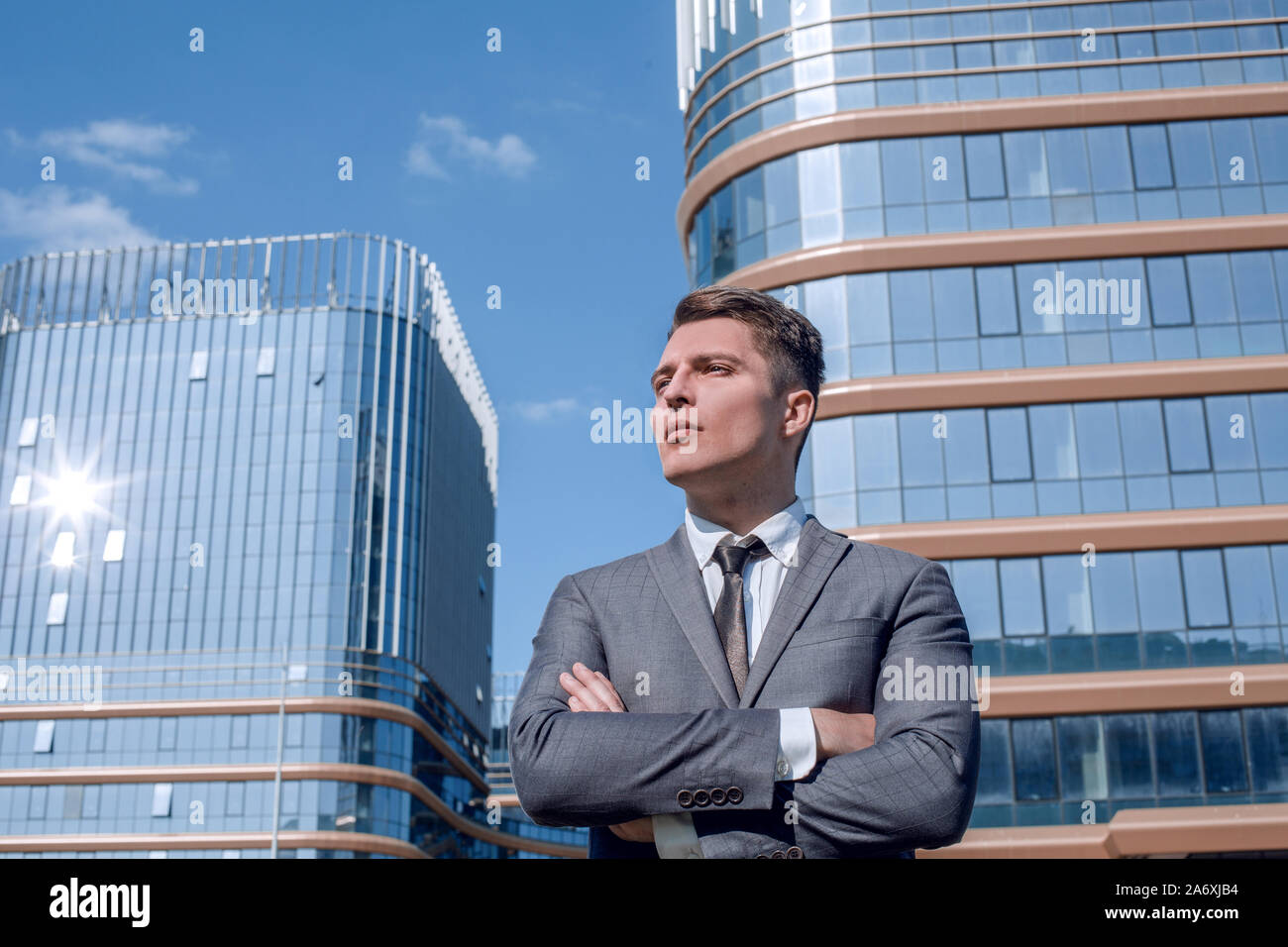 serious business man standing near a tall office building Stock Photo ...