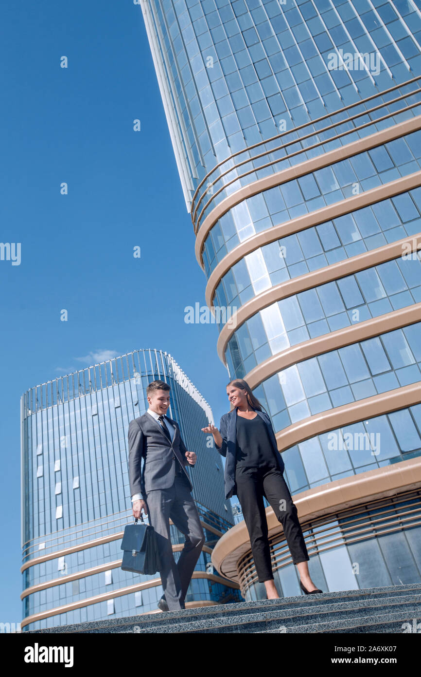 young corporate employees leaving the office building Stock Photo - Alamy