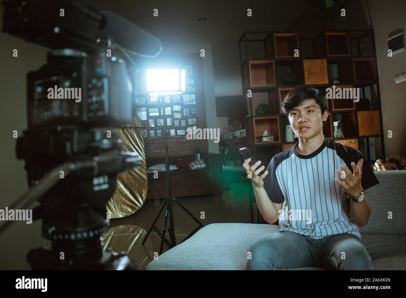 asian young man vlogger make video review about of new type smartphone ...