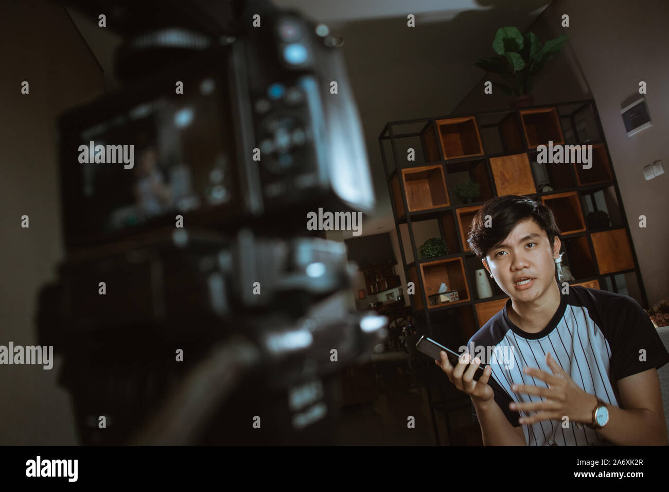 asian young man vlogger make video review about of new type smartphone ...