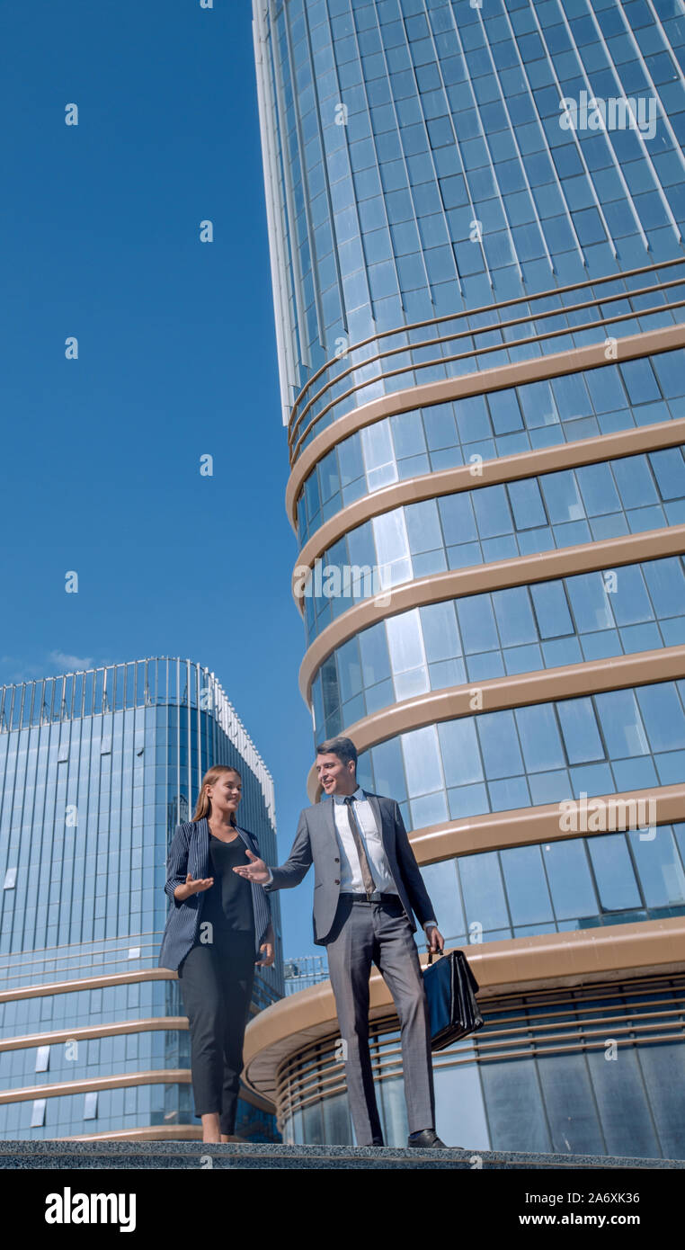 young corporate employees leaving the office building Stock Photo - Alamy